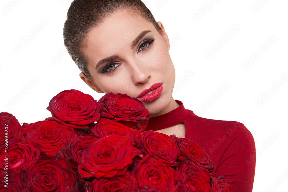 Beautiful model posing with red roses in the studio. Stock Photo ...