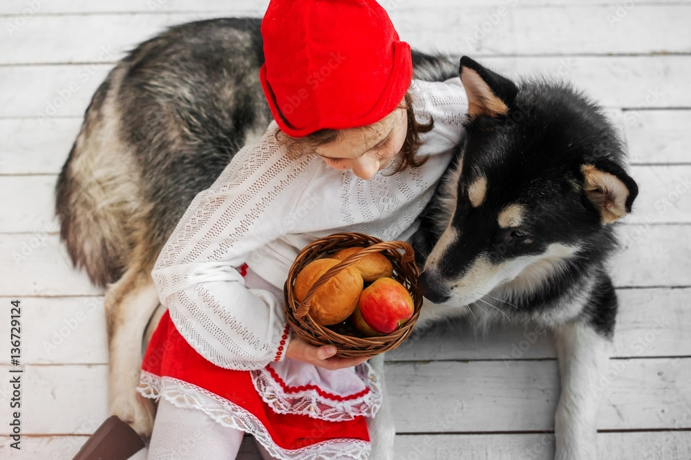 Girl child Little Red Riding Hood costume with a big dog. Stock Photo ...