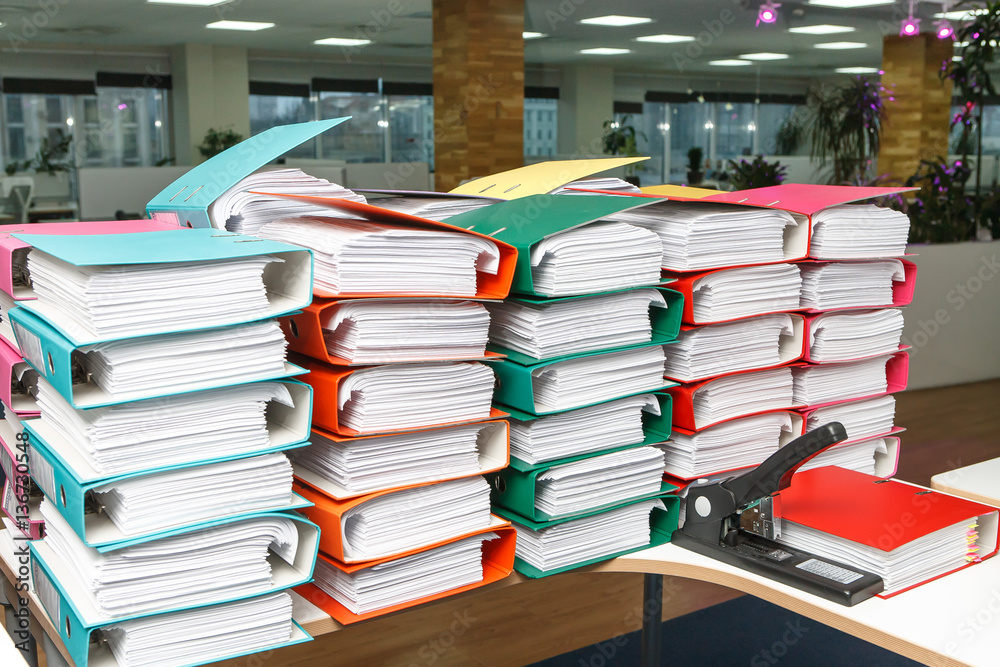Close up stack of paper on the office desk Photos | Adobe Stock