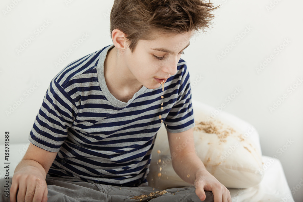 Young boy vomiting on his bed Stock Photo | Adobe Stock