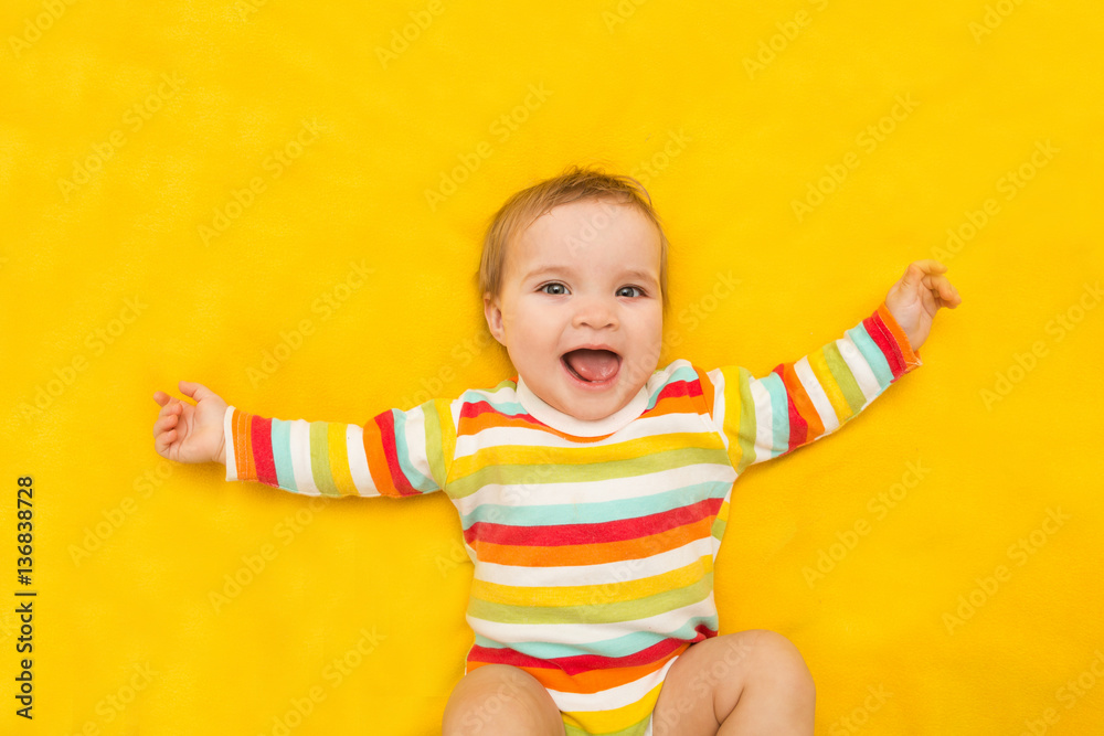 Portrait cheerful baby on a yellow background Stock Photo | Adobe Stock