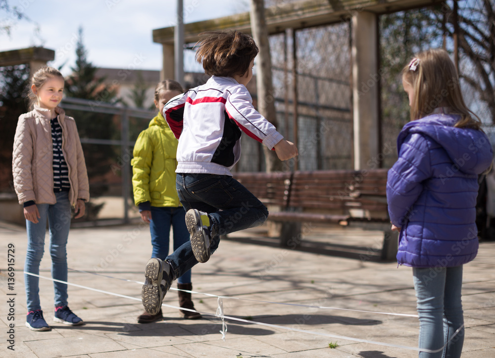active children games. Boy jumps over the rope Stock Photo | Adobe Stock