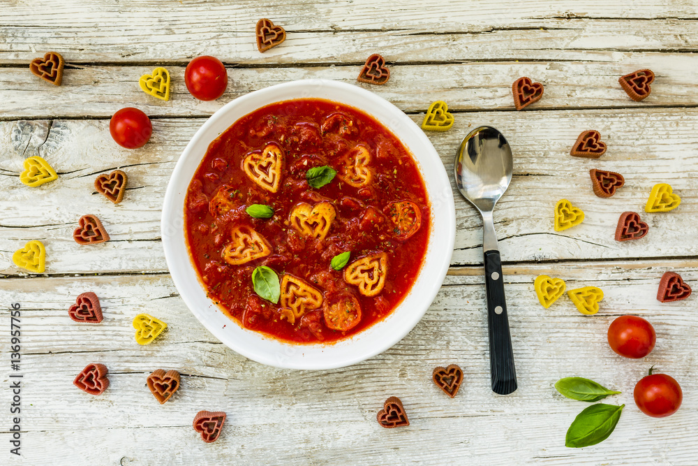 Tomato soup with heart-shaped pasta and basil on Valentine's Day. Stock ...