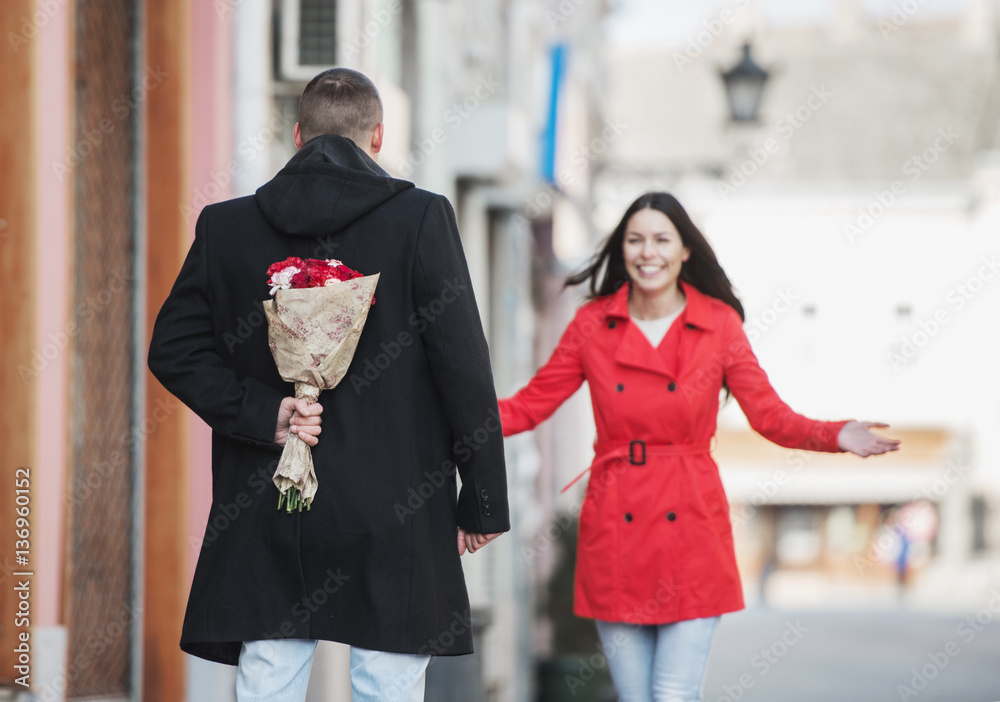 Man holding a flower bouquet behind his back, close up Stock Photo ...