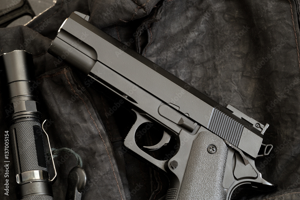 tactical flashlight and a gun - toys for grown-up children Stock Photo ...