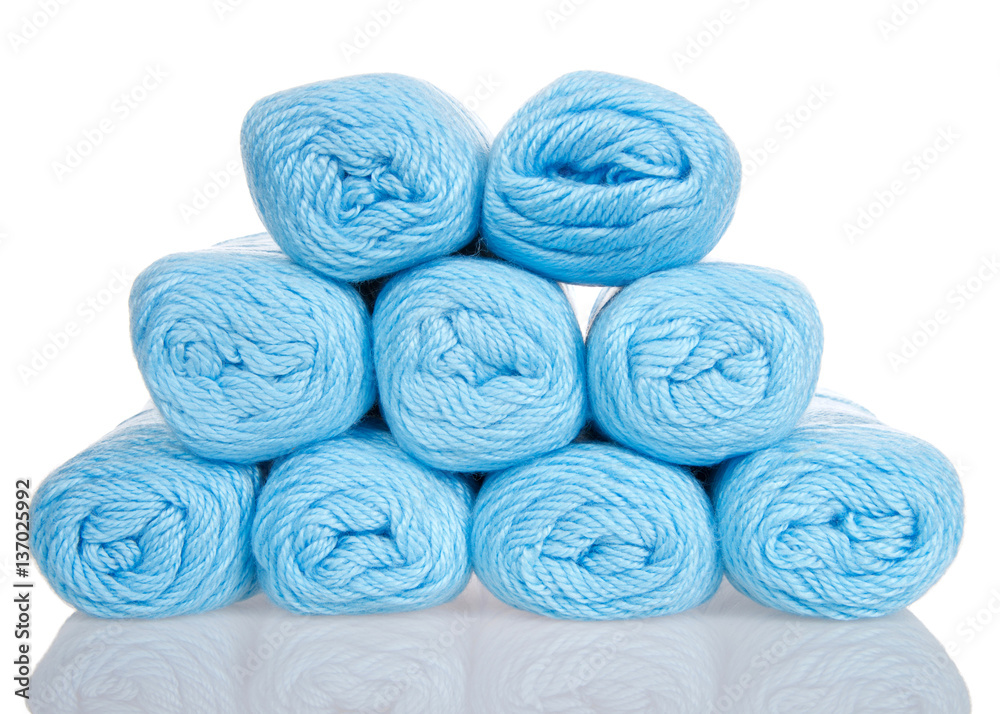 Skeins of powder blue light colored yarn stacked into a pyramid ...