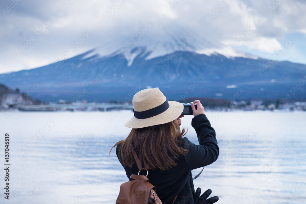 Lady tourist is taking photography of Mt. Fuji at Lake Kawaguchi in ...