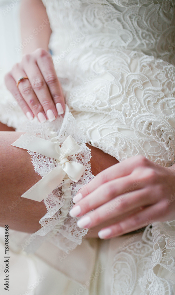 The bride putting on garter Stock Photo | Adobe Stock