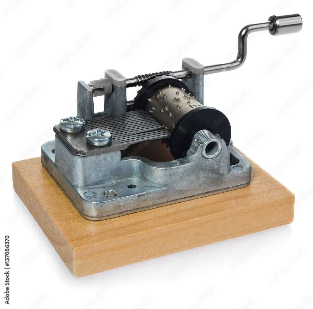 The mechanism of silver music box with a handle on a wooden board ...
