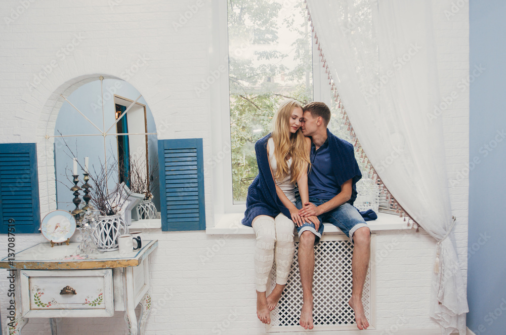 Couple in love sitting at home on the window. Tender loving embrace of ...