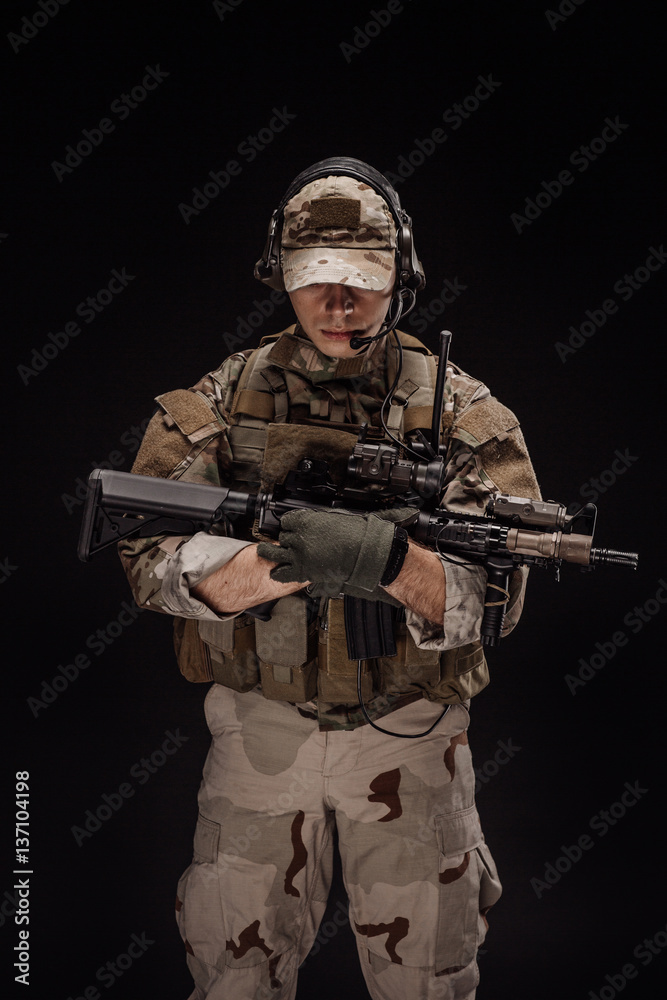 Portrait soldier or private military contractor holding sniper rifle ...