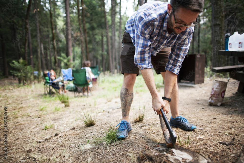Man cutting wood with axe Stock Photo | Adobe Stock