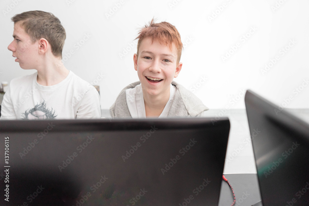 student smiling. happy schoolboy. a young boy with a laptop working ...