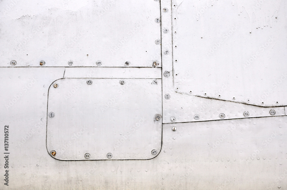 Vintage background. White metal airframe surface divided into ...