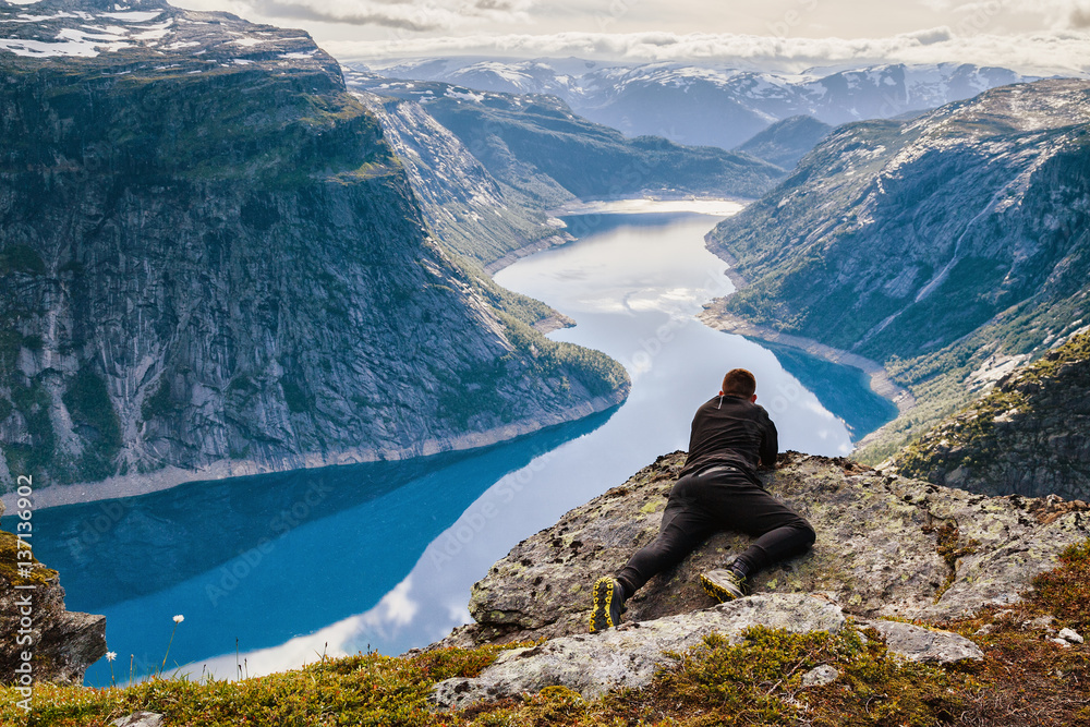 Fotka „Norway, Hardangervidda national park. Young hiker laying at the ...