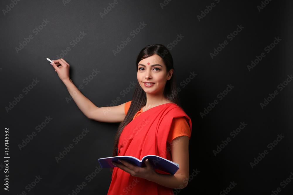 Portrait of Indian female teacher on blackboard background Stock Photo ...