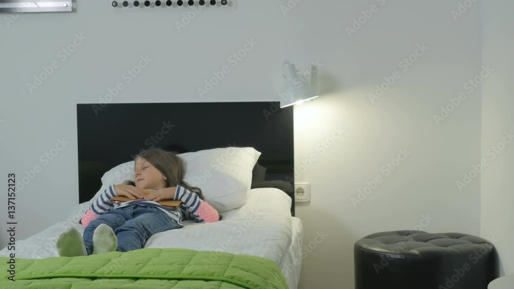Little girl fall asleep and mother comes and covers the daughter with a ...