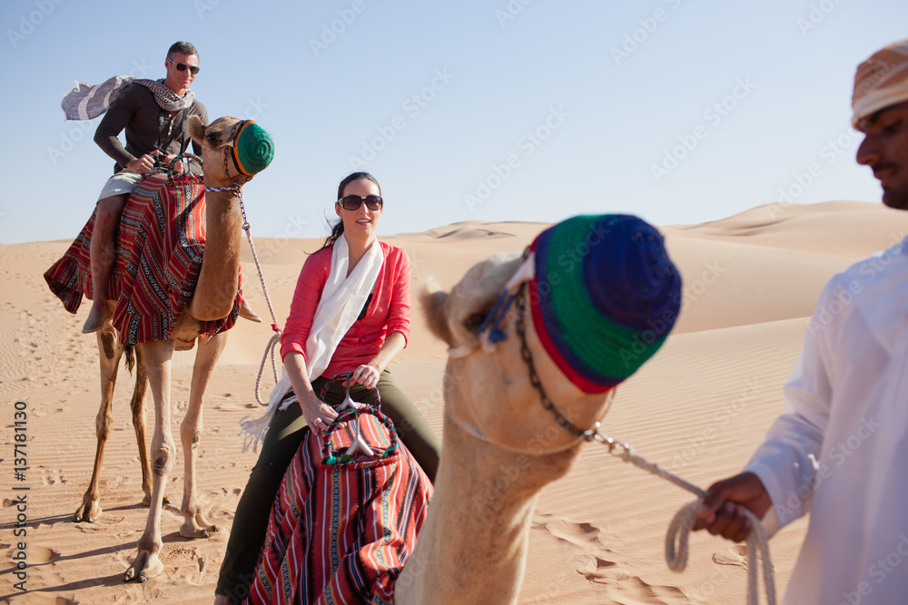 Couple riding on camel at desert. Stock Photo | Adobe Stock