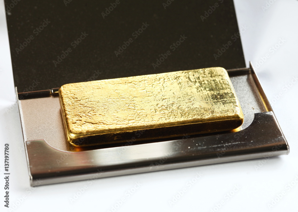 The gold bar put in the metal name card box represent gold and business ...