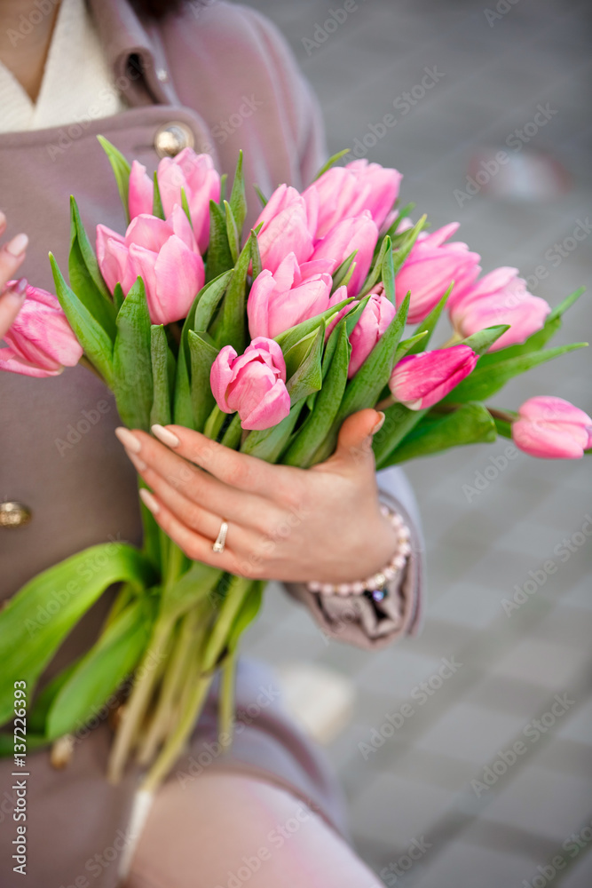 Happy smiling girl with spring tulips flowers outdoors Stock Photo ...