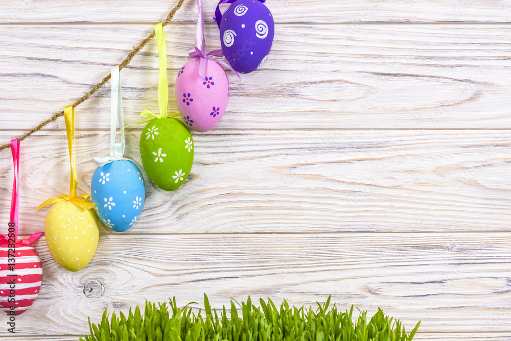 Colorful easter eggs hanging on rustic wooden background with space ...