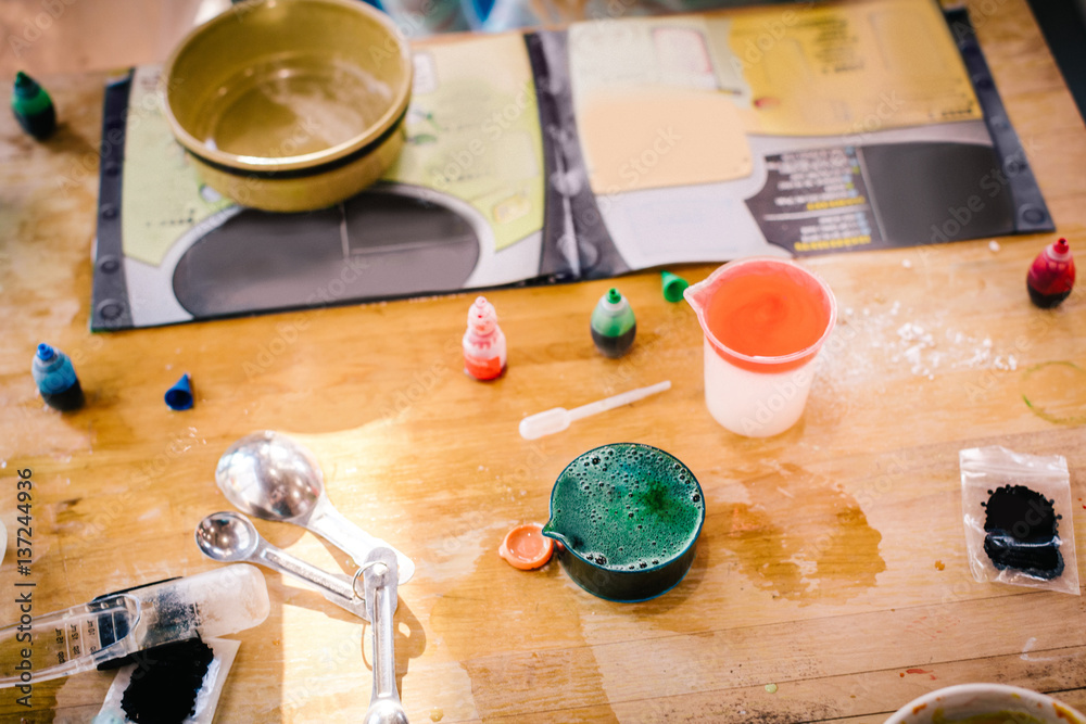 Child's messy chemistry set science experiment on table with ...