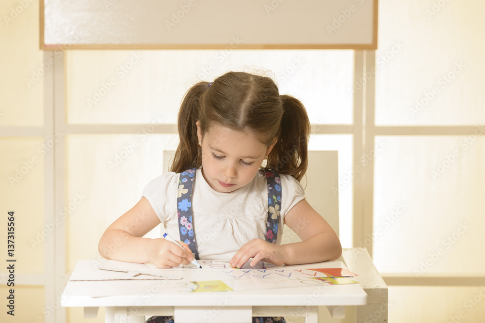 Little child writing letters. Learning to write. Little girl writing ...