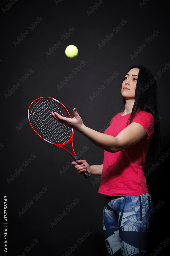 Woman with a tennis racket in his hand throwing a tennis ball Stock ...