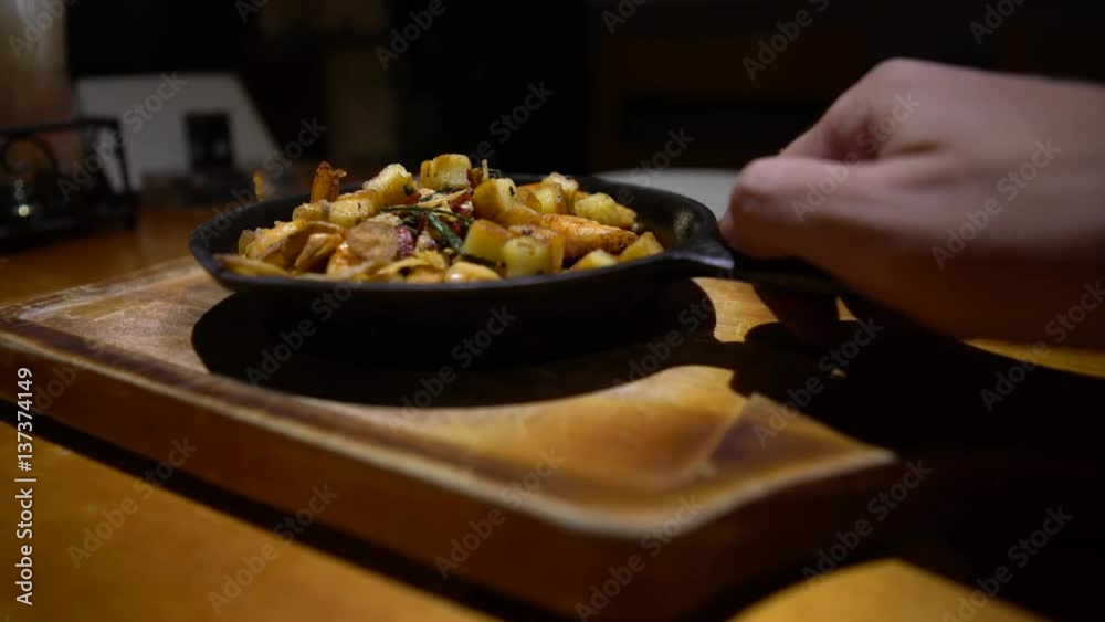 4K Waiter serving in a modern restaurant brings a delicious fresh dish ...