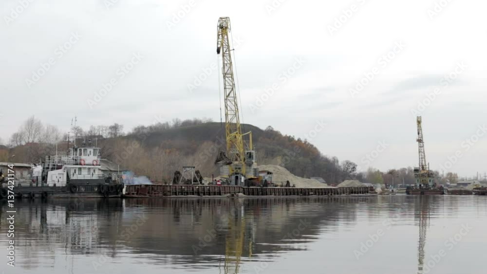 The industrial port pour sand on the barge with a crane Stock Video ...