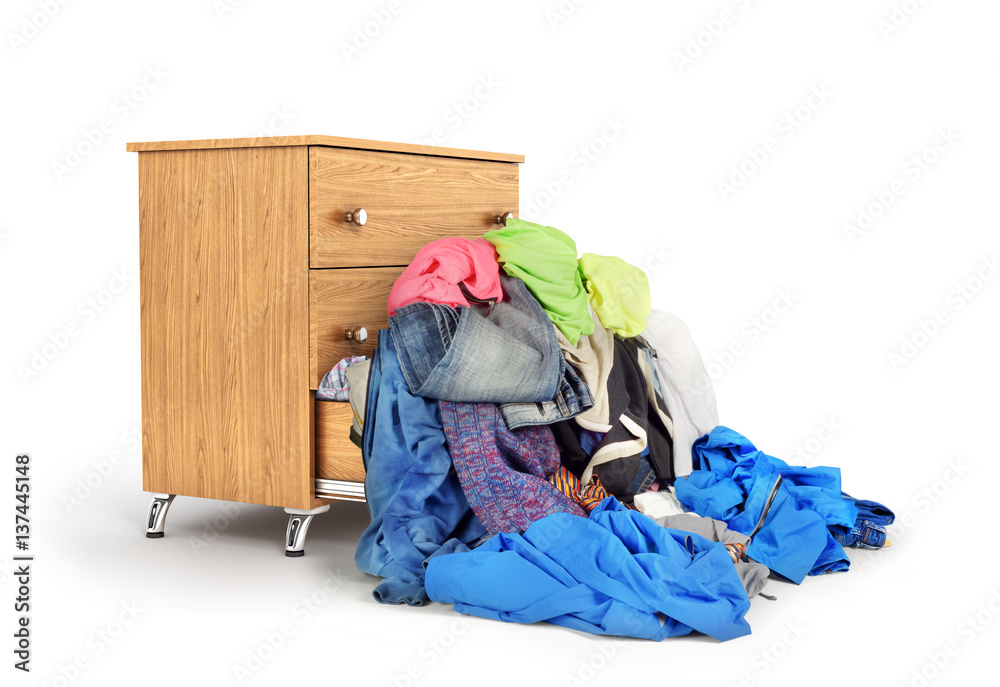 A pile of clothes falling out of the dresser isolated on white ...