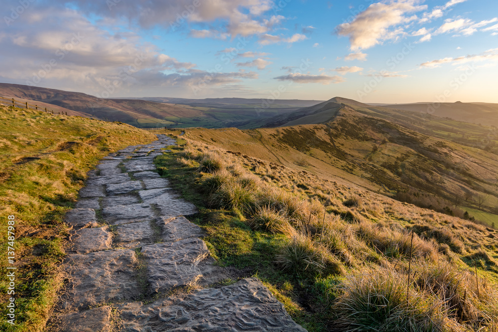 Rural stone footpath trail on ridge of hills in the British Peak ...