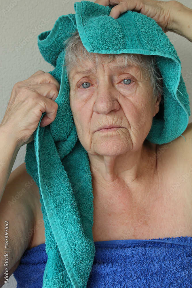 senior women towel drying her hair after shower Photos | Adobe Stock