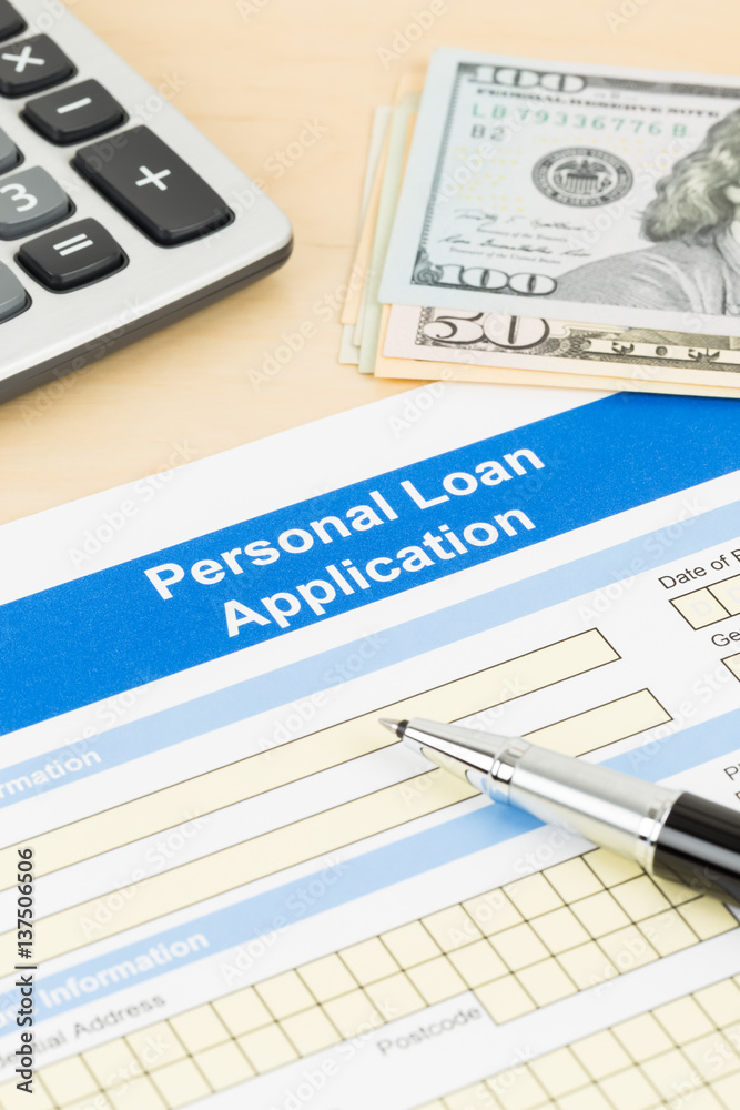 Personal loan application form with calculator, dollar money, and pen ...