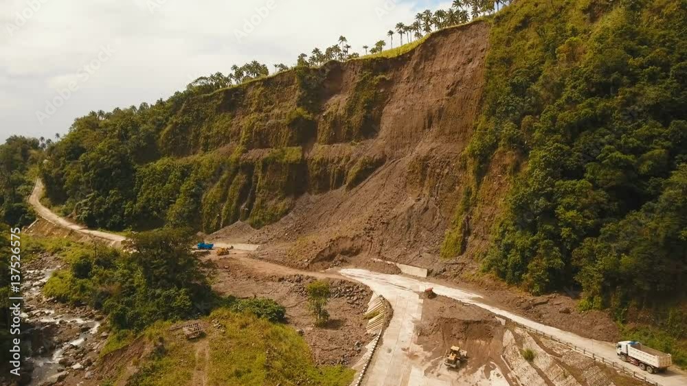 Landslides and rockfalls on the road in the mountains.Aerial view: mud ...