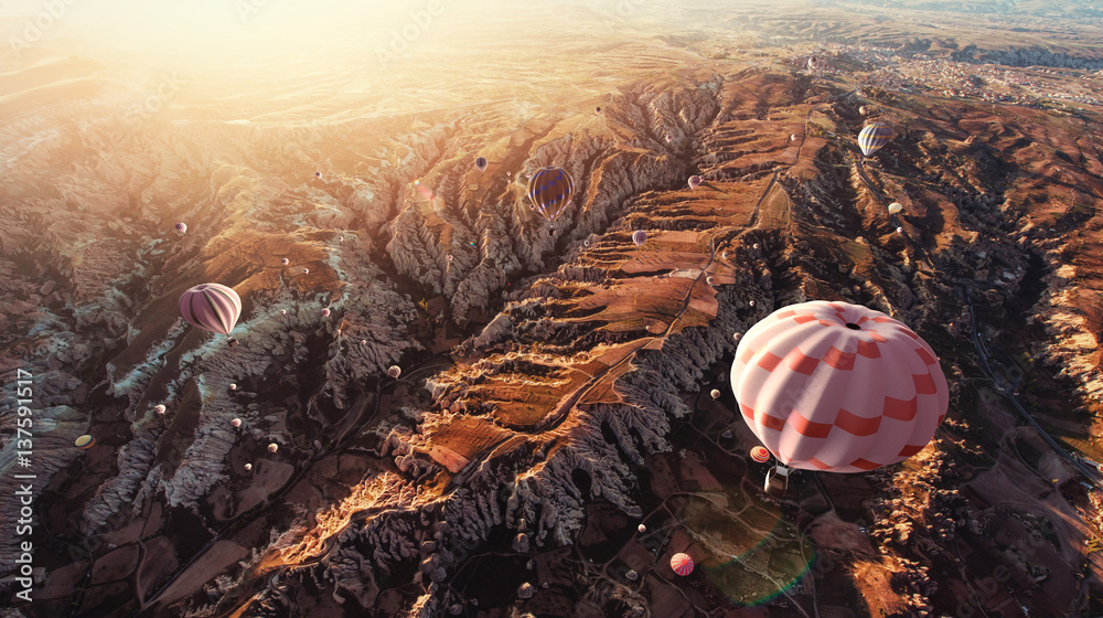Hot air balloon flying over rock landscape at Turkey. Cappadocia Stock ...