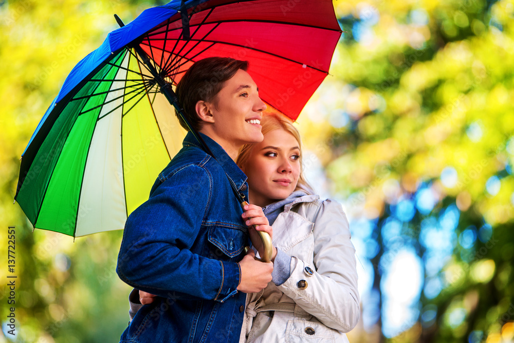 Autumn couple walking park. Fall friends walk under rain umbrella ...