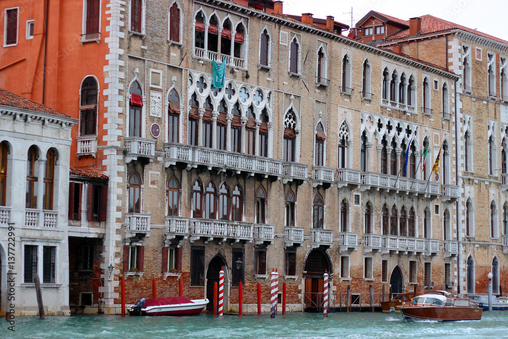 View of the Grand Canal with gondolas and colorful facades of old ...