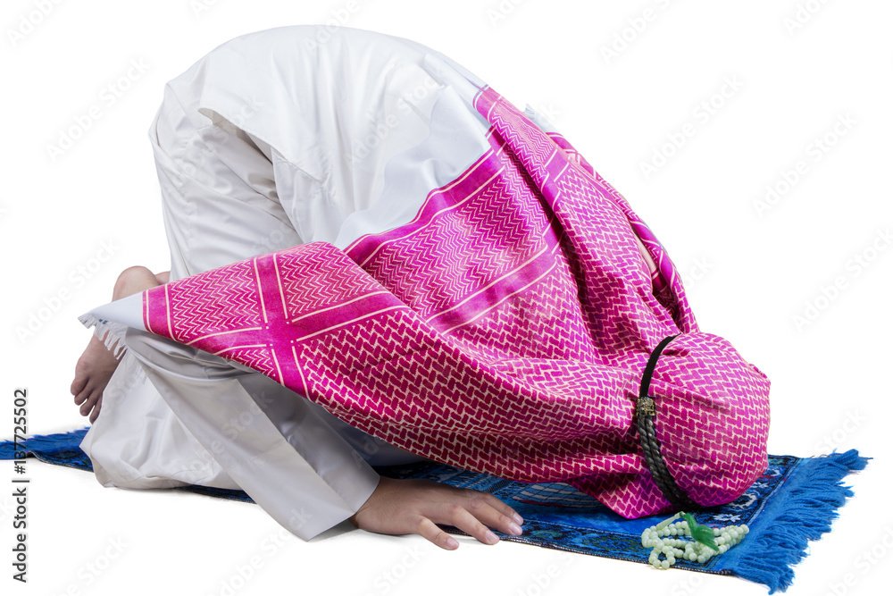 Muslim male posing prostration on studio Stock-Foto | Adobe Stock