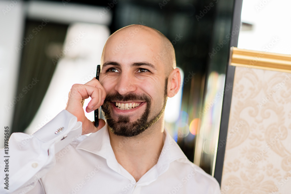 Bald man businessman talking on phone. Stock Photo | Adobe Stock