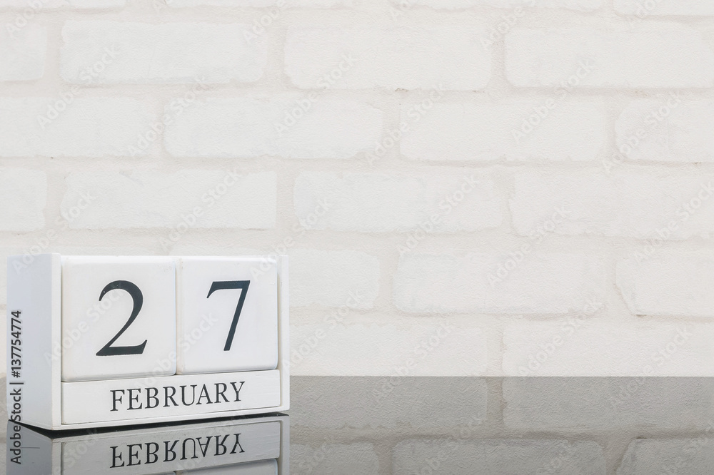 Closeup white wooden calendar with black 27 february word on black ...