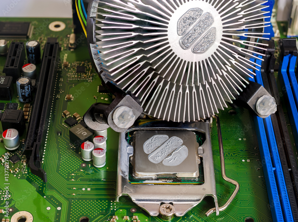 The cooling fan and CPU thermal paste applied before mounting the ...