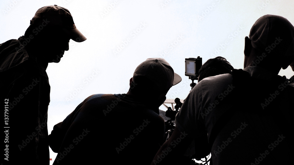 Film crew team camera man and director recording TV commercial and ...