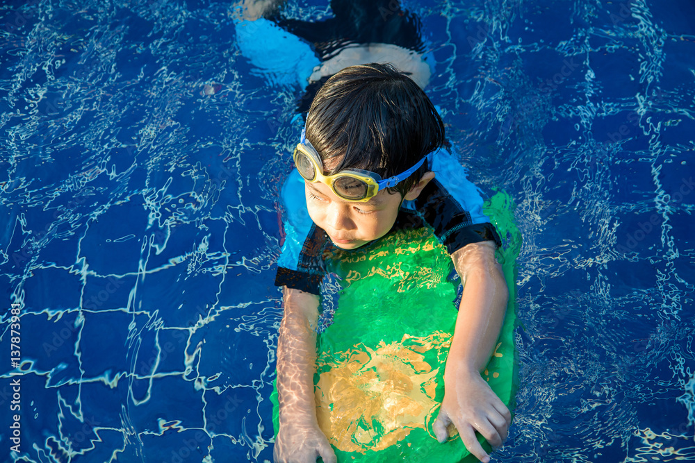 boy learn to swim in the swimming pool Stock Photo | Adobe Stock