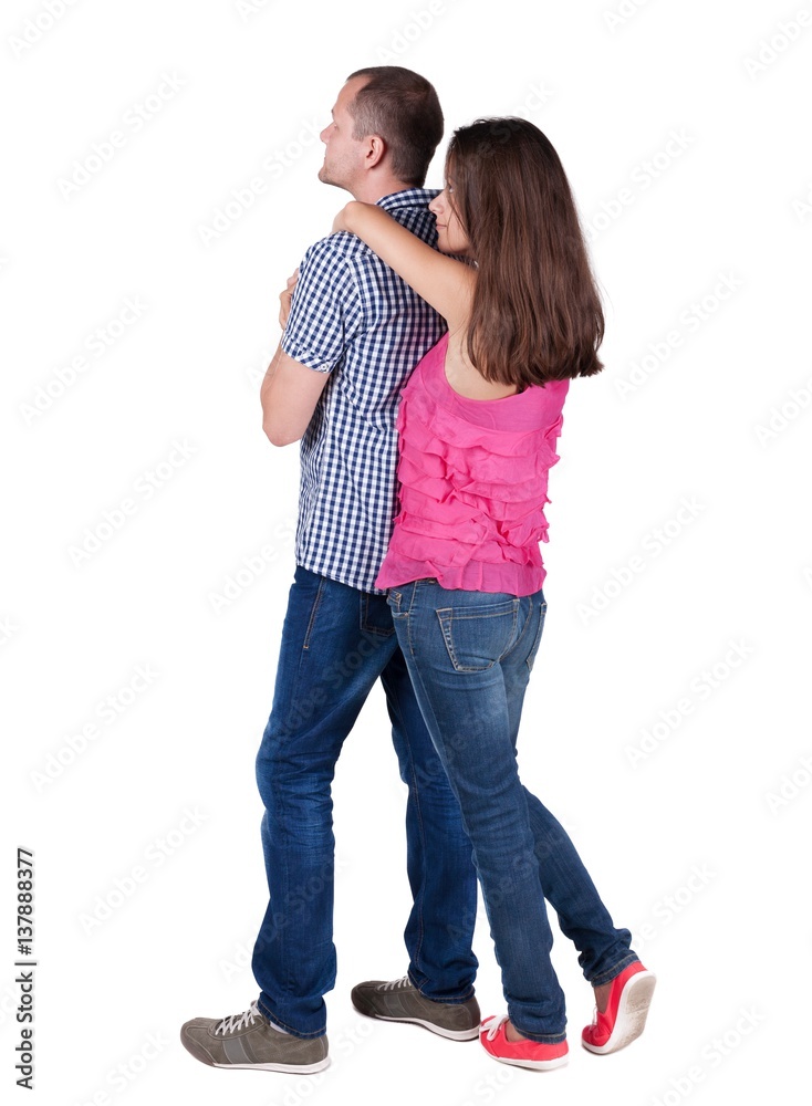young couple pointing at wal Back view woman and man . looking into the ...