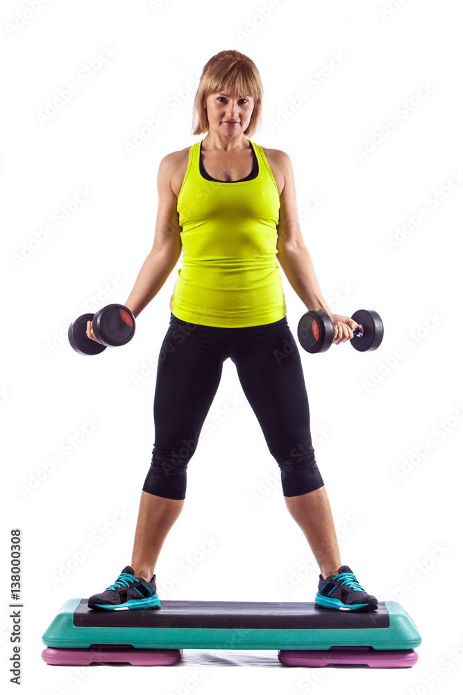 Fitness girl is working out with stepper , isolated on white background ...