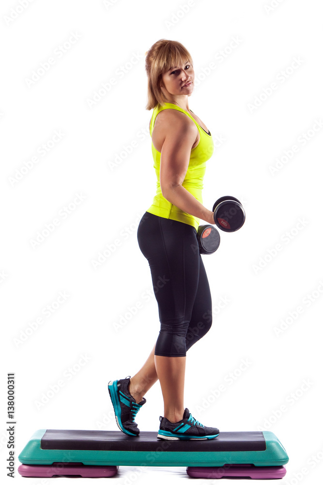 Fitness girl is working out with stepper , isolated on white background ...