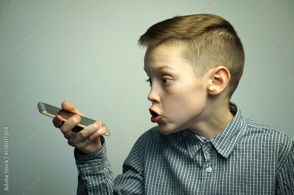 Angry teenage boy talking on smartphone Stock Photo | Adobe Stock