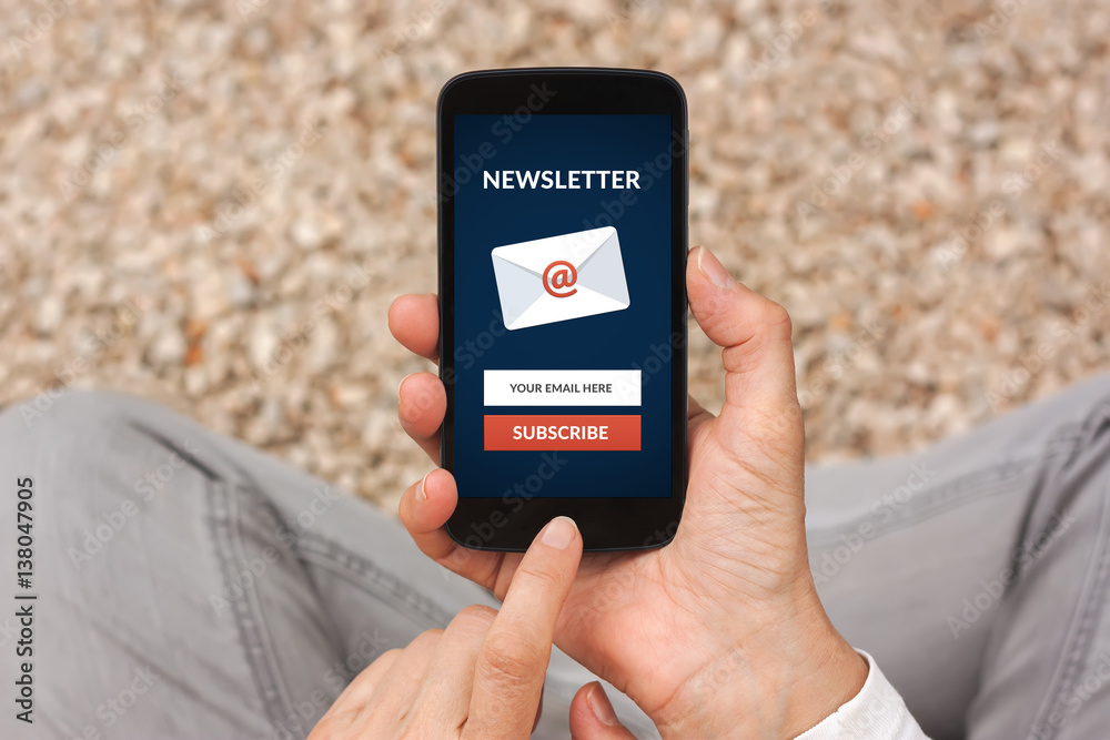 Hands holding smart phone with subscribe newsletter concept on screen ...