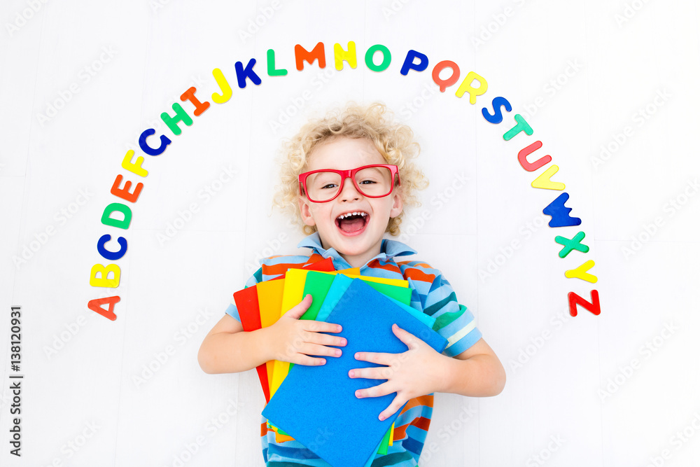 Child learning letters of alphabet and reading Stock Photo | Adobe Stock